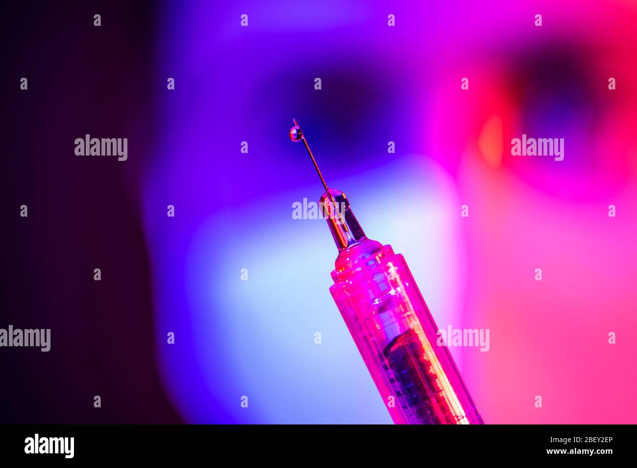 Syringe, medical injection in hand, detail on water drop. Medicine ...