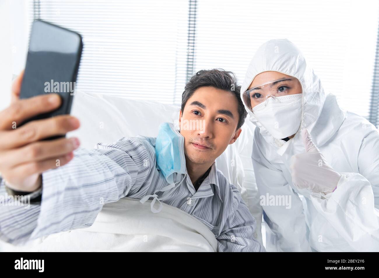 Doctors and patients to watch mobile phones Stock Photo - Alamy