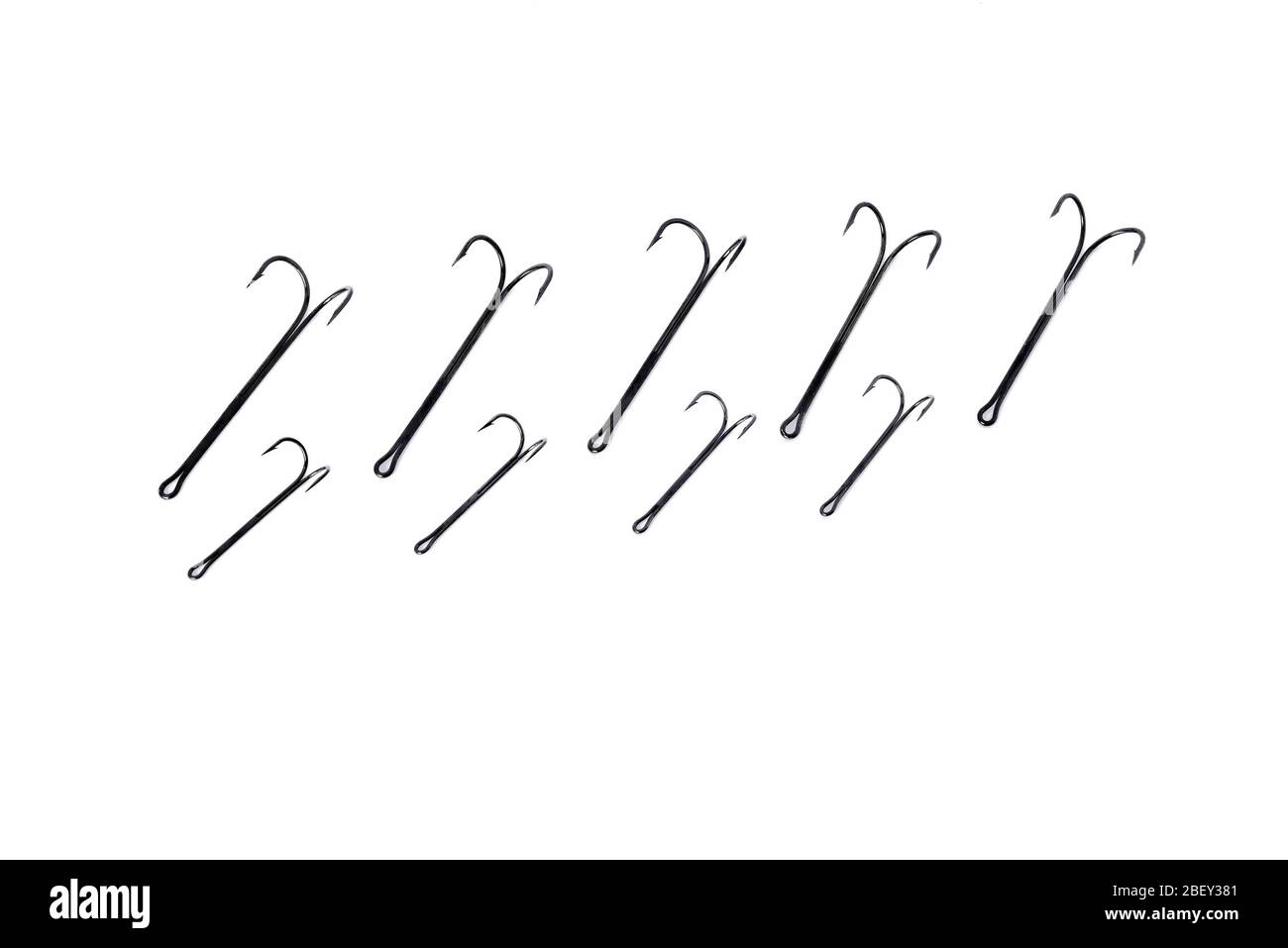 double hooks for fishing of various sizes on a white background close ...