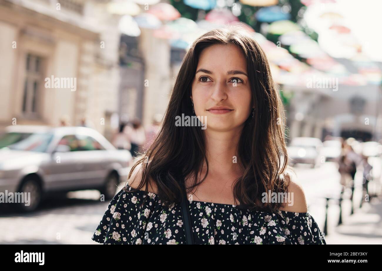 Beautiful smiling woman walking on crowded city street Stock Photo - Alamy