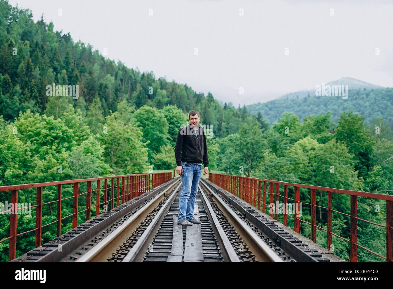 Man sitting on railway platform hi-res stock photography and images - Alamy