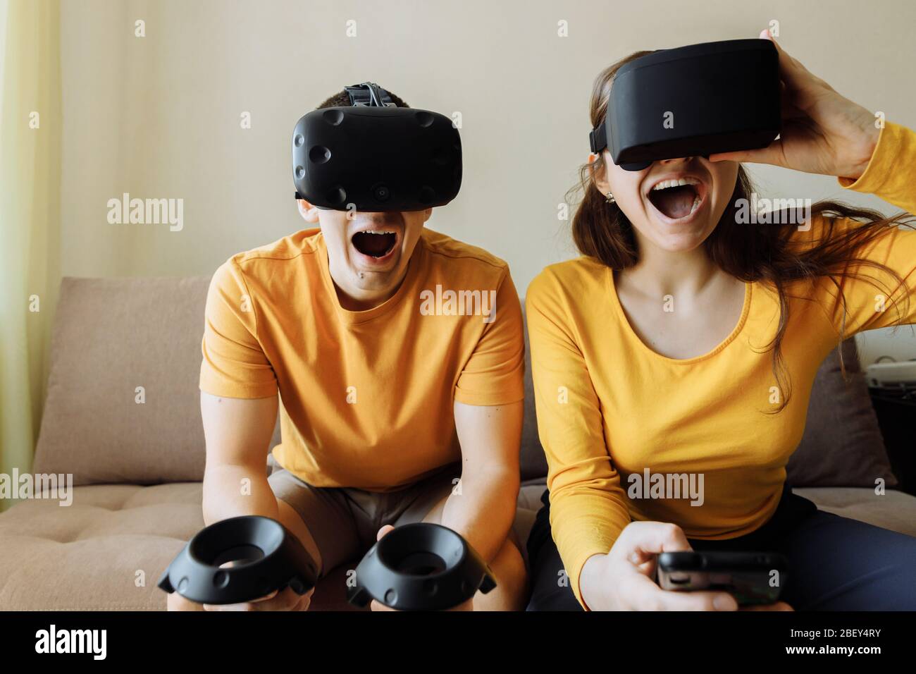 What to do at home. A guy and a girl play virtual games. People are ...