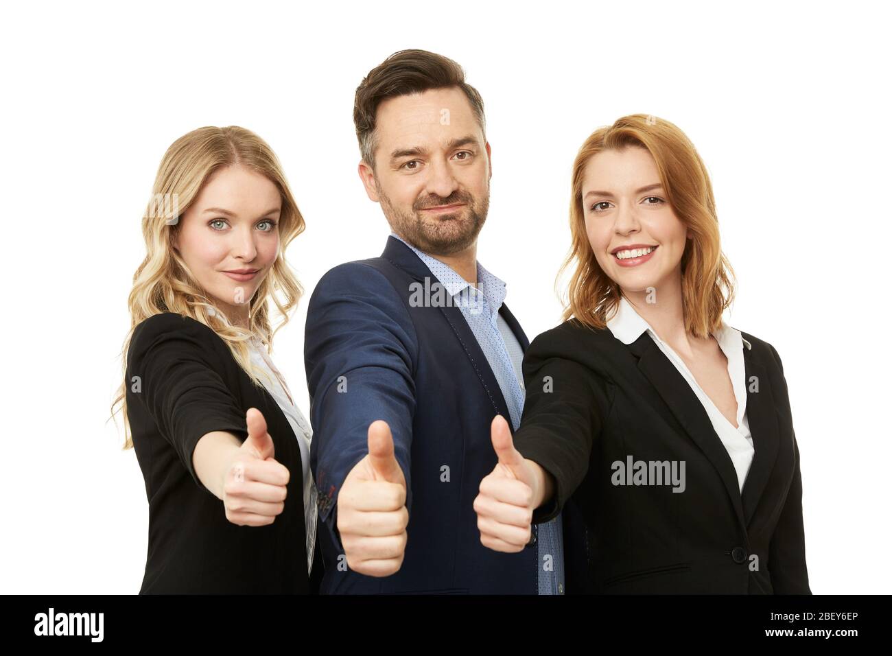 Businessman with two beautiful businesswomen. Teamwork. Thumbs up Stock ...