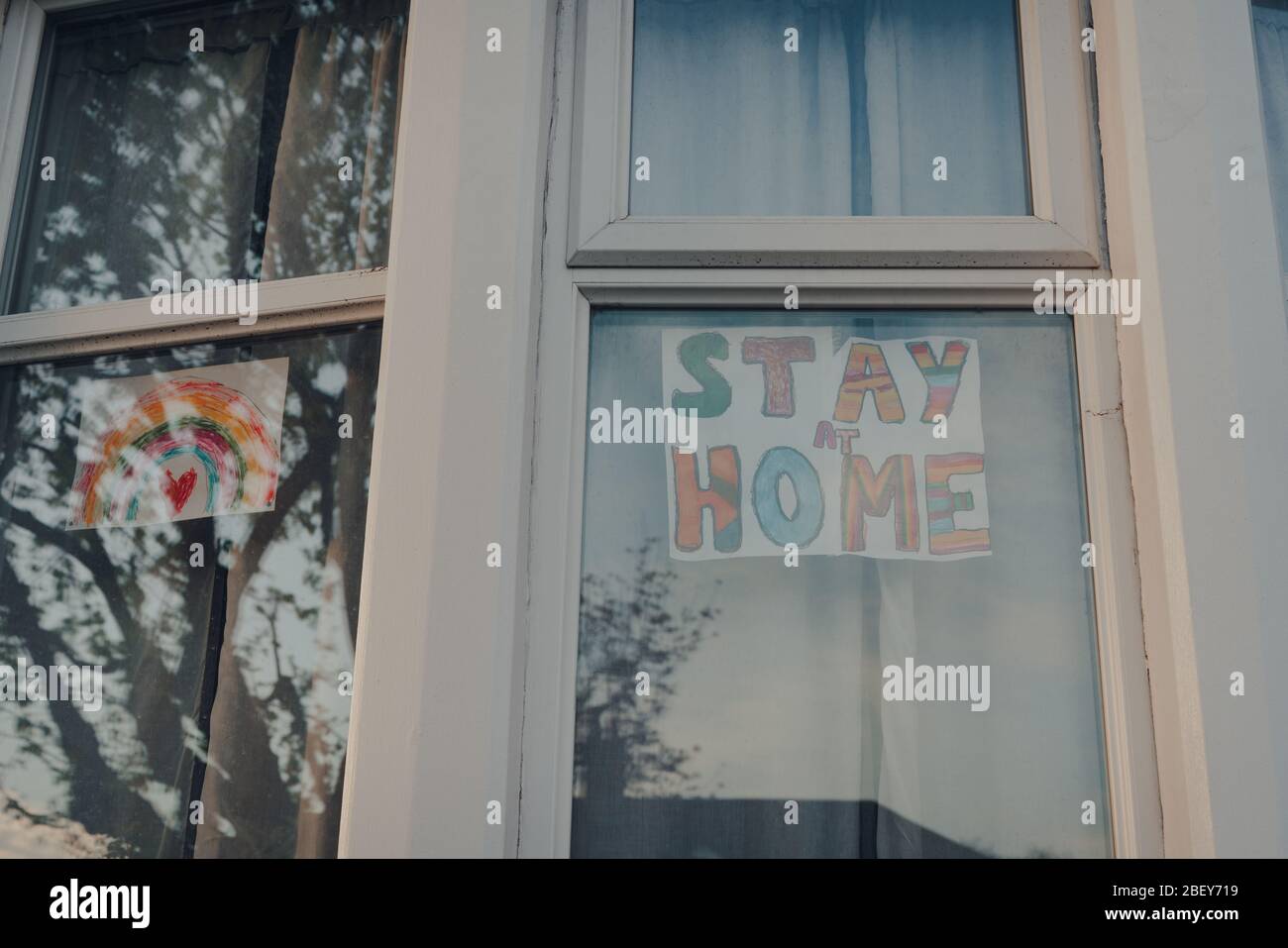 London, UK - April 12, 2020: Handmade stay home sign displayed in a ...