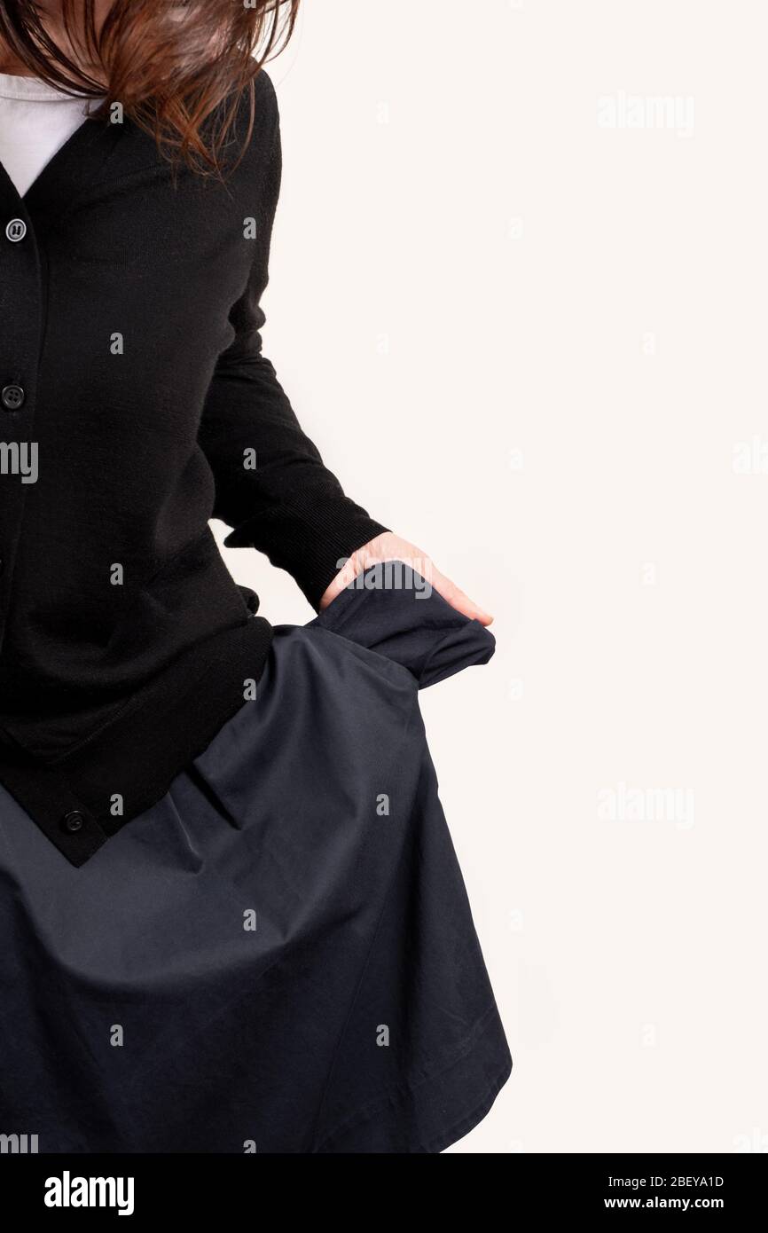 Woman is holding empty pockets on her clothes, isolated on white ...