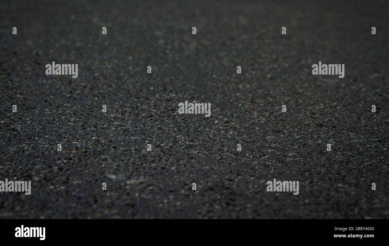 The surface of the black asphalt is a soft focus. Dark Tar Asphalt ...