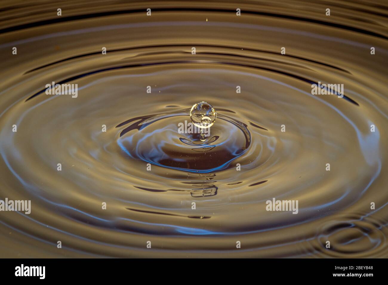 Splash of water crown on colored surface Stock Photo - Alamy