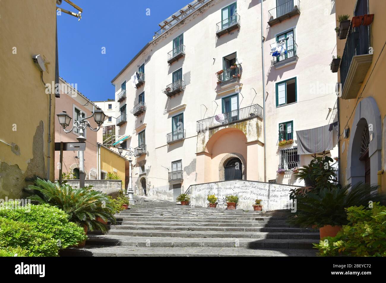 A narrow street between the old houses of Salerno, a city in the ...