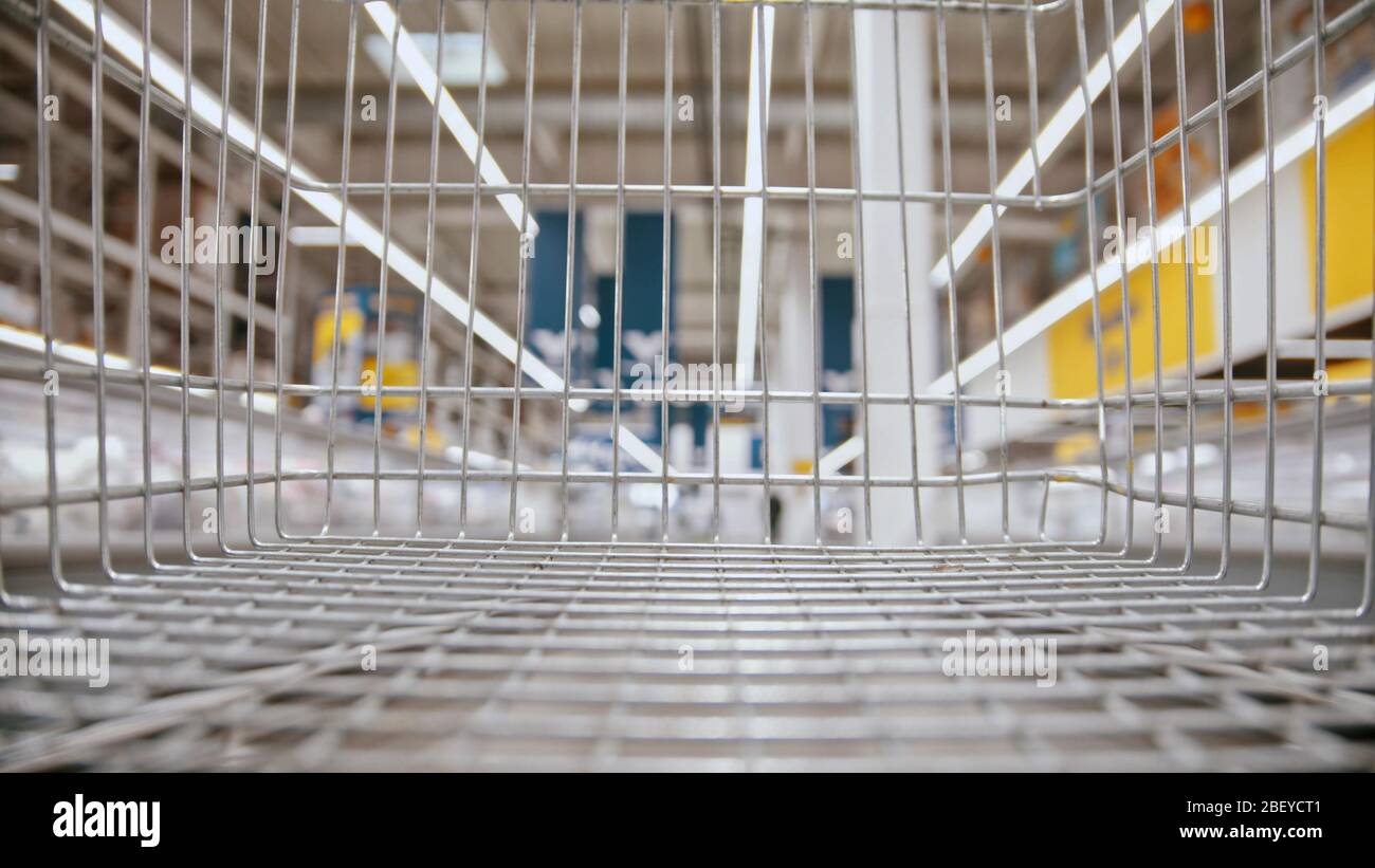 an empty grocery trolley in the big supermarket. mid shot Stock Photo ...