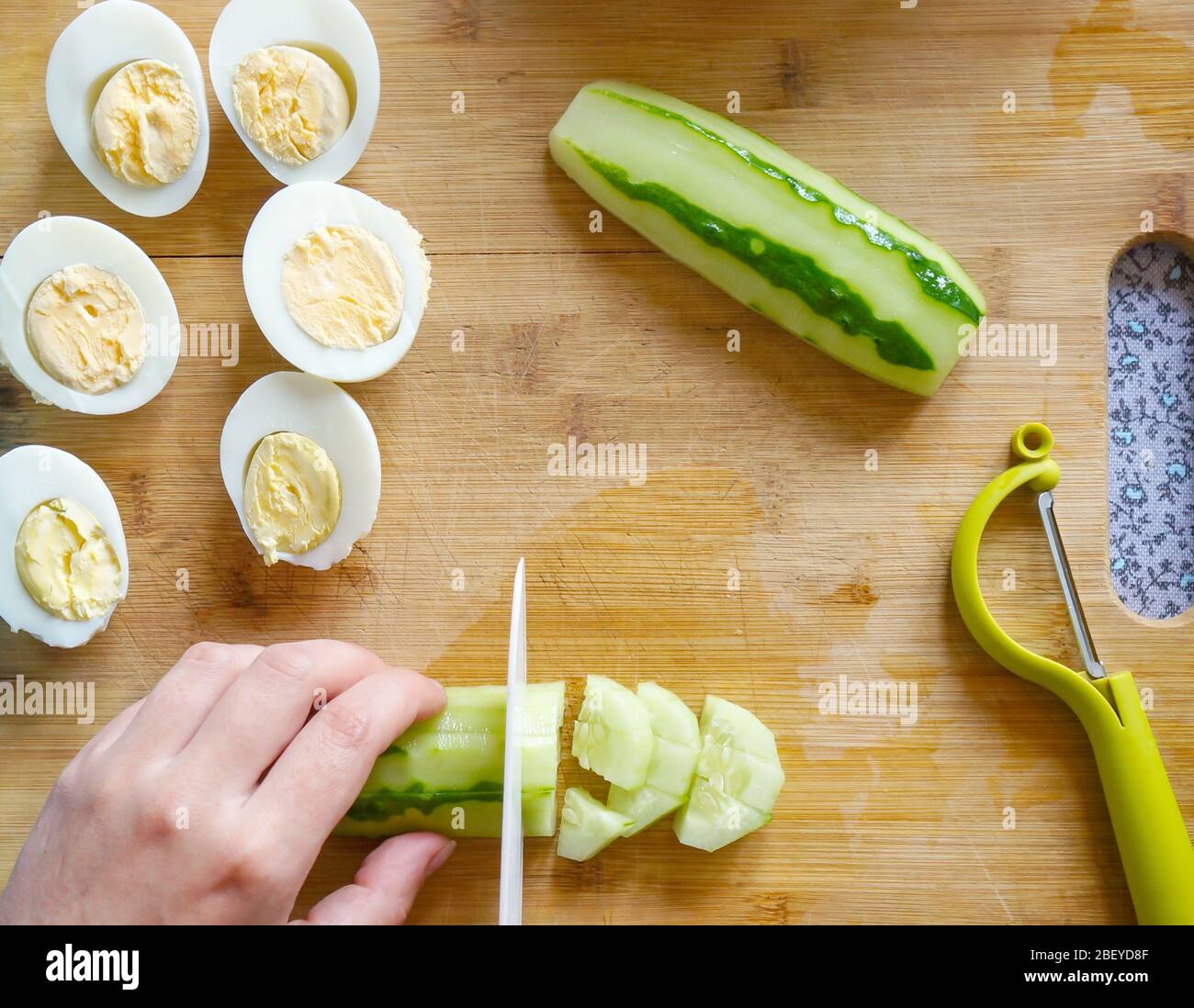 cutting vegetables for salad on a cutting wooden board Stock Photo - Alamy