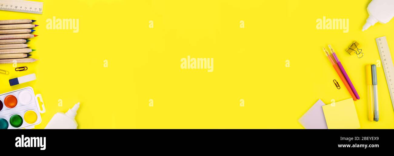 Banner made from different school supplies on bright yellow paper ...