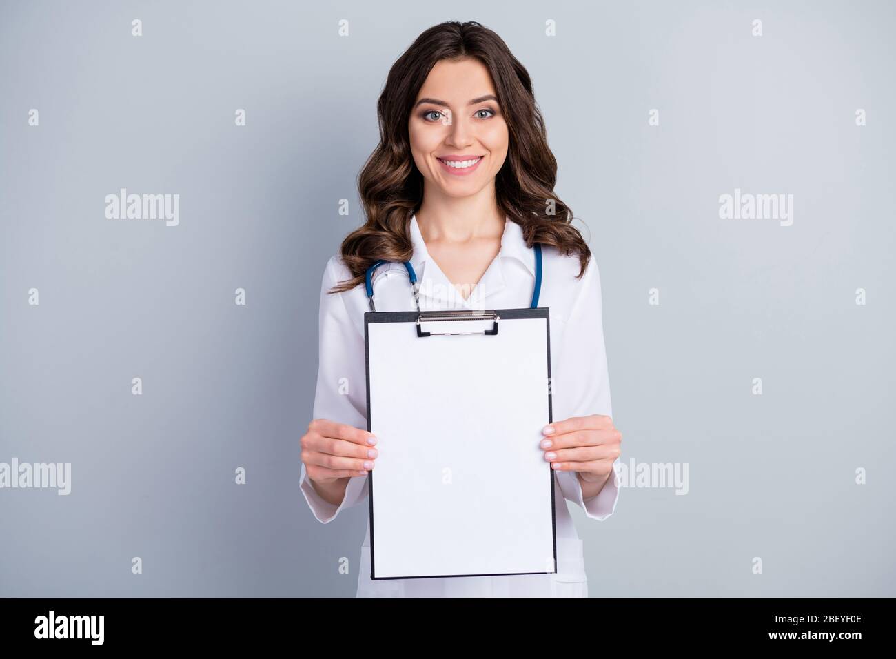 Portrait of qualified successful practitioner cardiologist girl hold ...