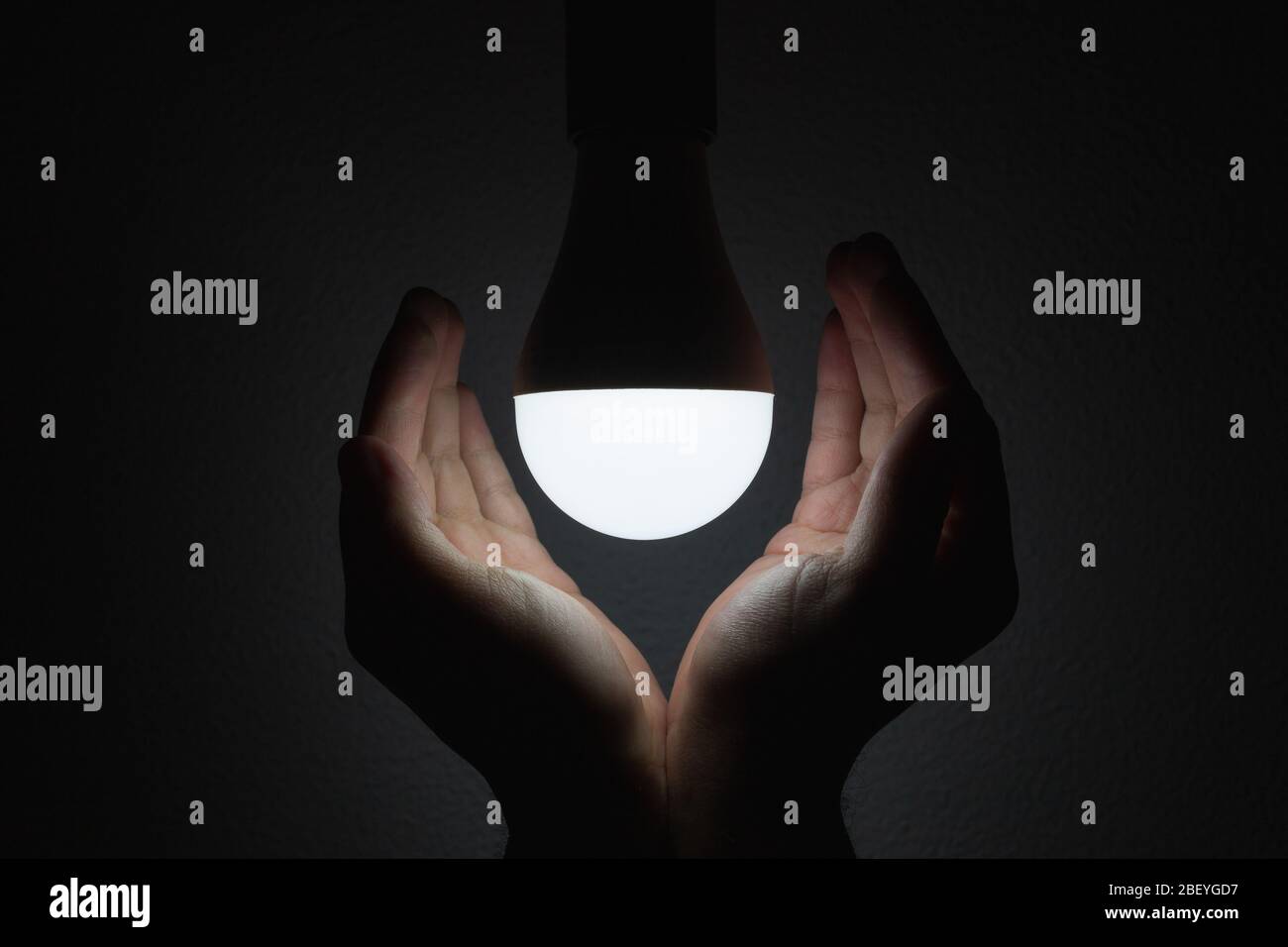 LED bulb with lighting in the human hand with dark background Stock ...