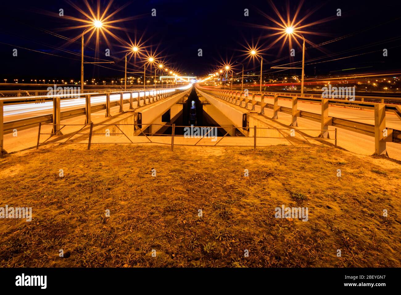 Moving car with blur light through city bridge at night Stock Photo - Alamy