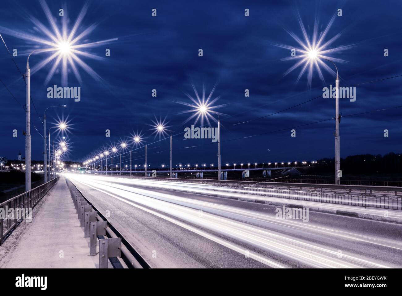 Moving car with blur light through city bridge at night Stock Photo - Alamy