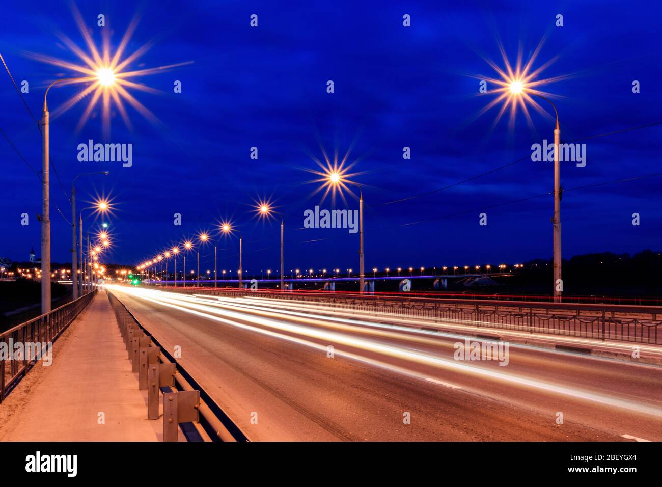 Moving car with blur light through city bridge at night Stock Photo - Alamy