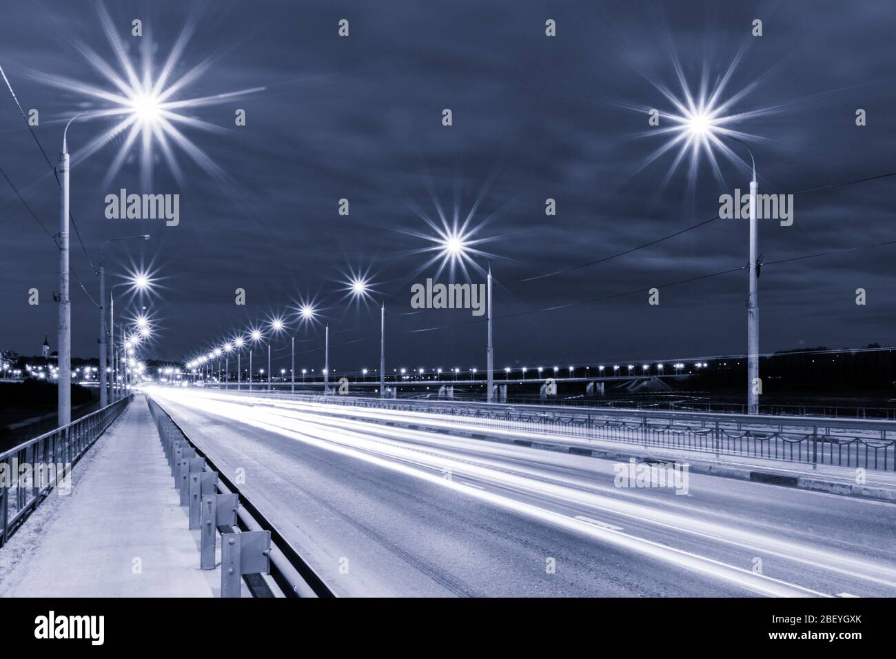 Moving car with blur light through city bridge at night Stock Photo - Alamy
