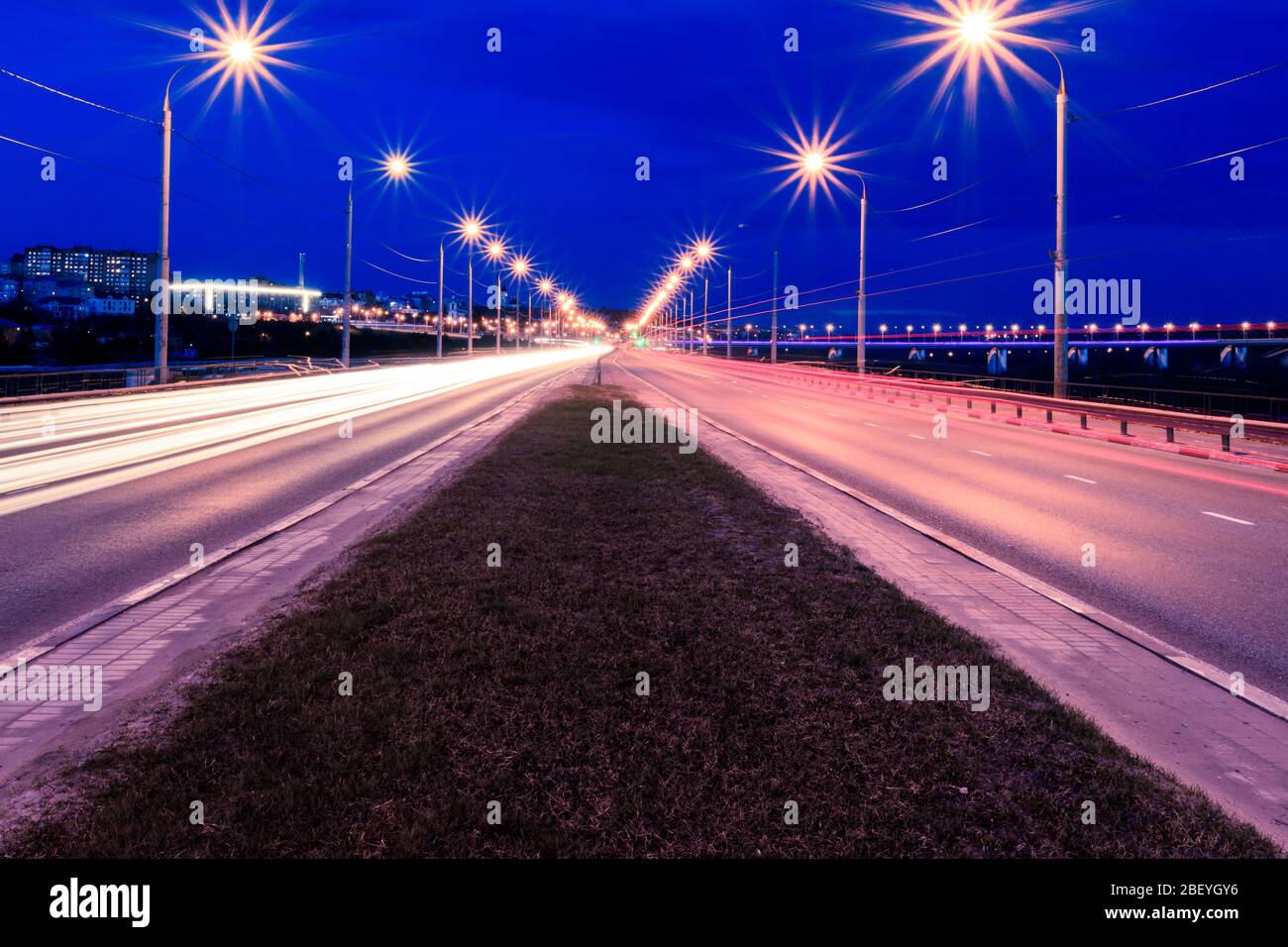 Moving car with blur light through city bridge at night Stock Photo - Alamy