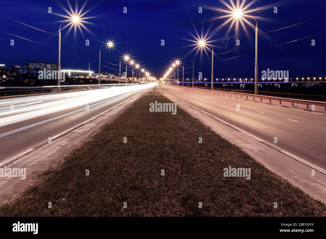Moving car with blur light through city bridge at night Stock Photo - Alamy