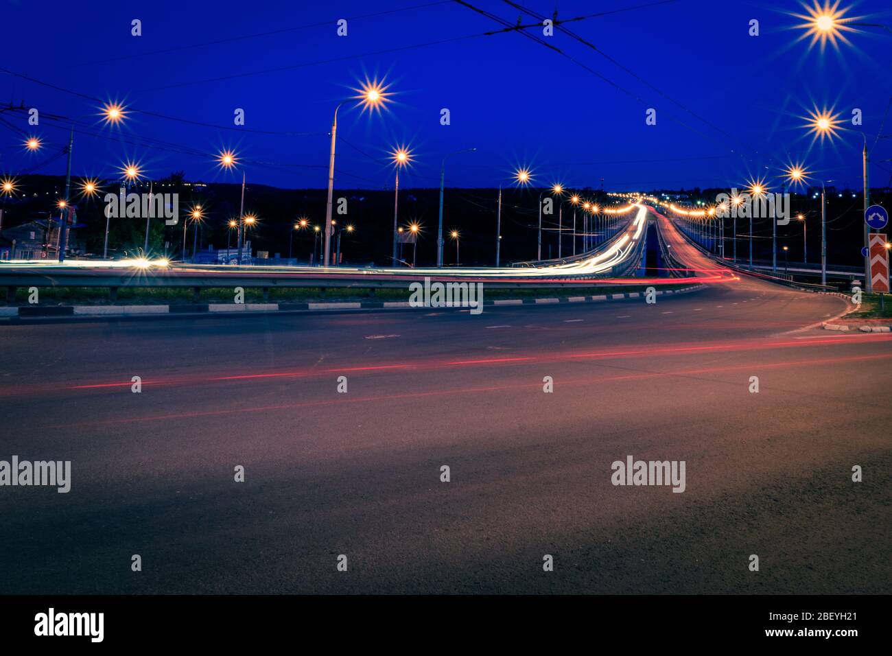 Moving car with blur light through city bridge at night Stock Photo - Alamy