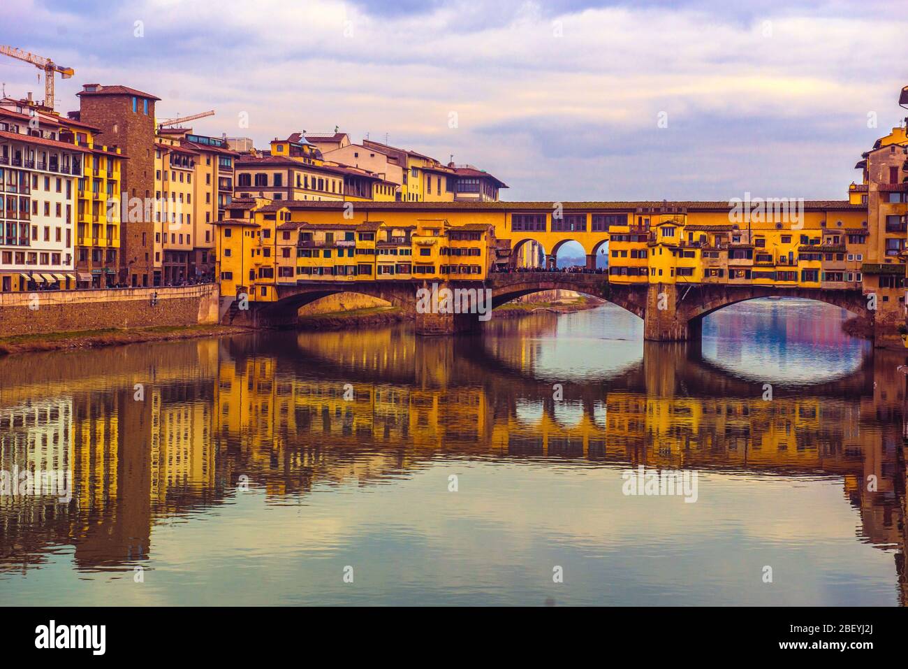 The Ponte Vecchio, famous medieval stone bridge over the Arno River in ...
