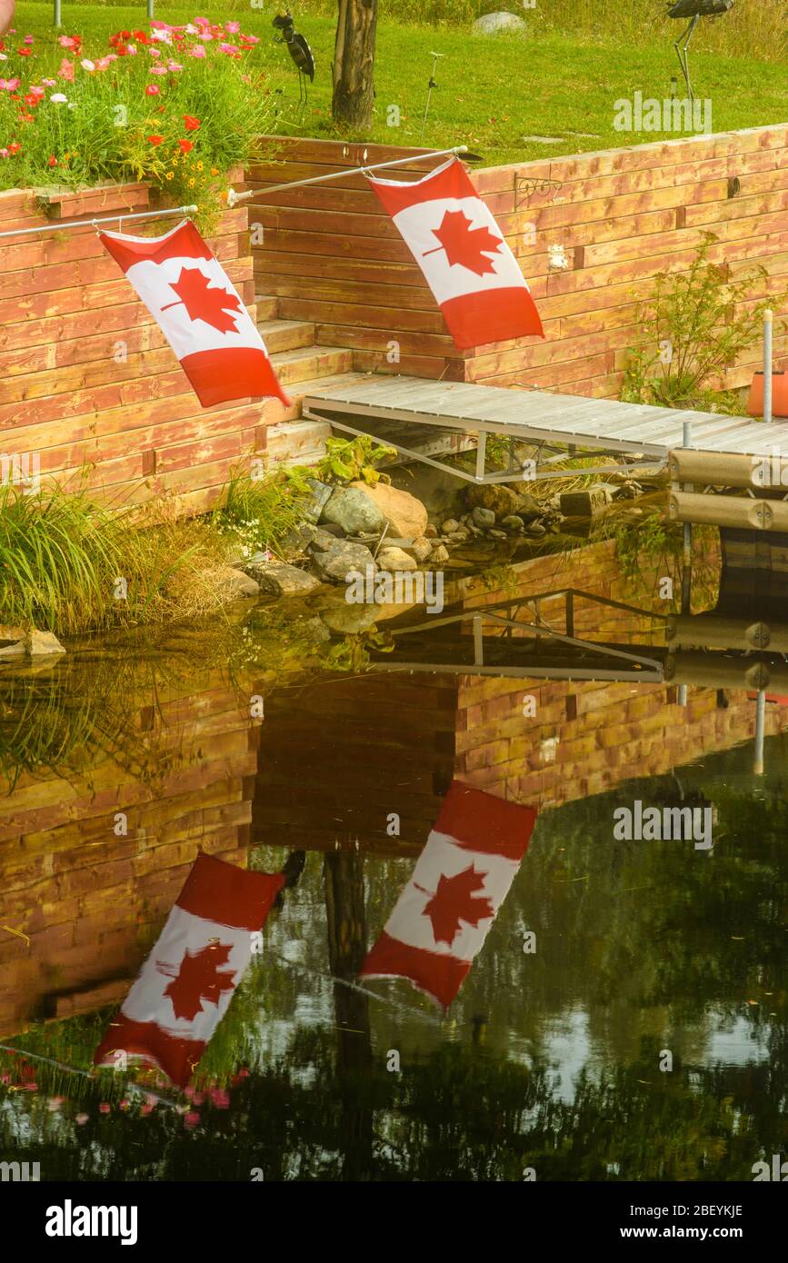Canadian flags reflected in the Wanapitei River, Greater Sudbury ...