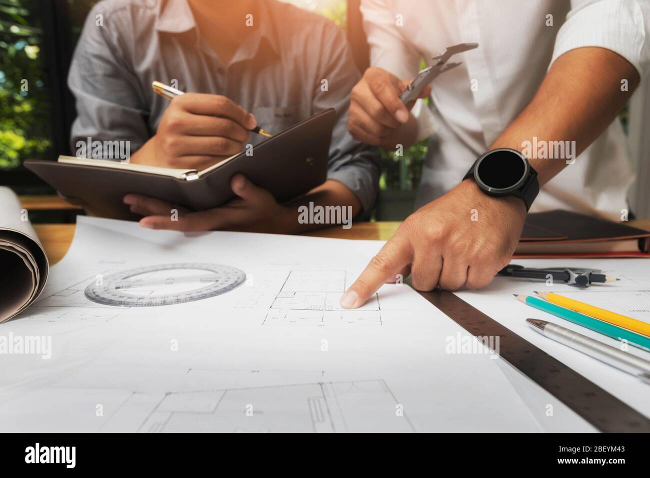 Confident team of architect working together in a office.They discussing about new startup ...