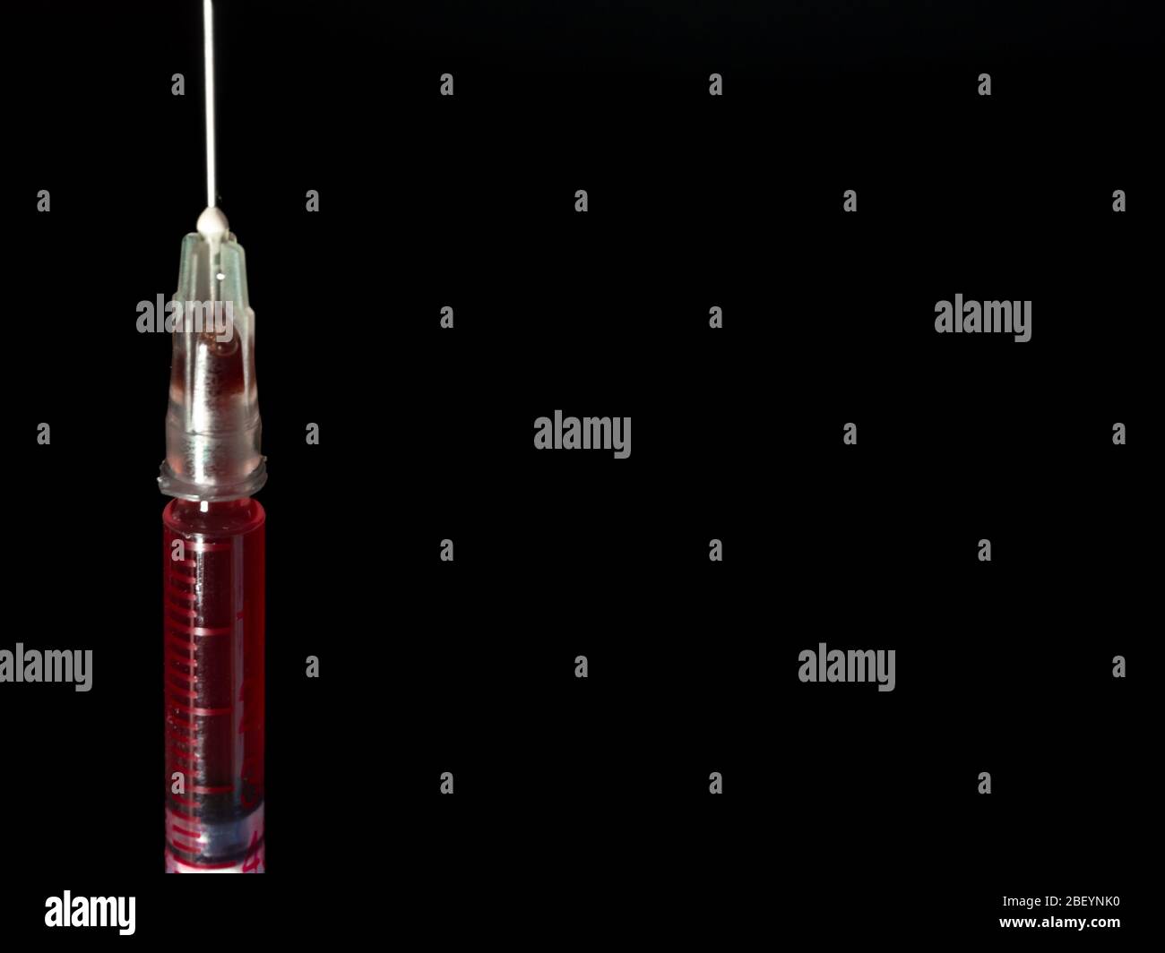 Syringe, injection needle on black background Stock Photo - Alamy