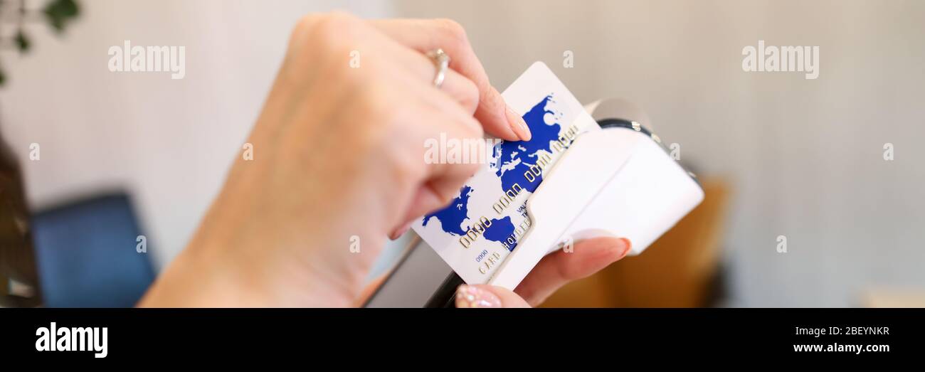 Hands hold portable terminal for card payment Stock Photo - Alamy