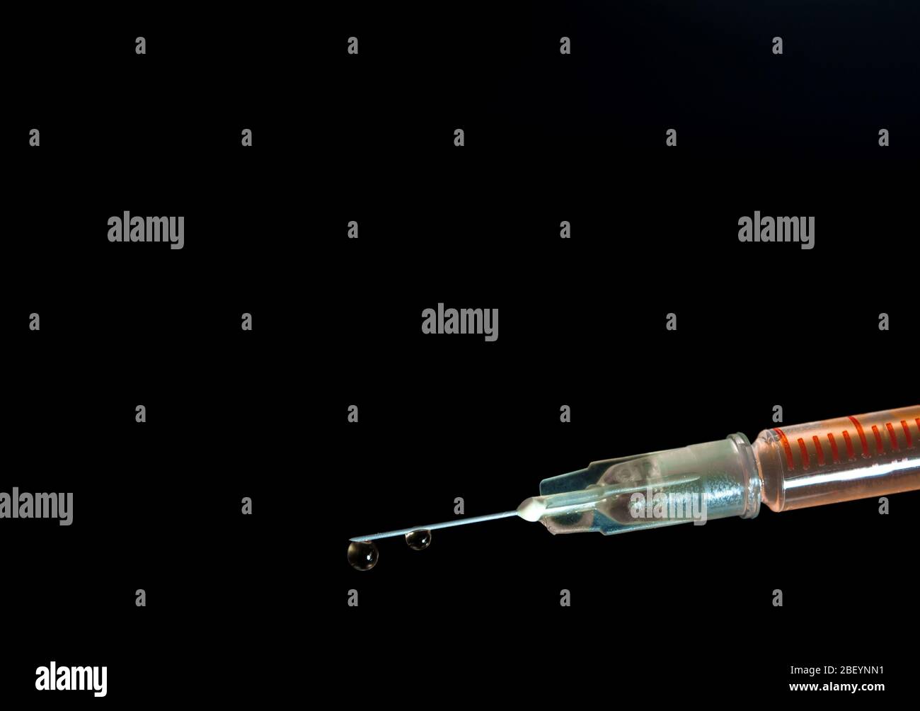 Syringe, injection needle on black background Stock Photo - Alamy