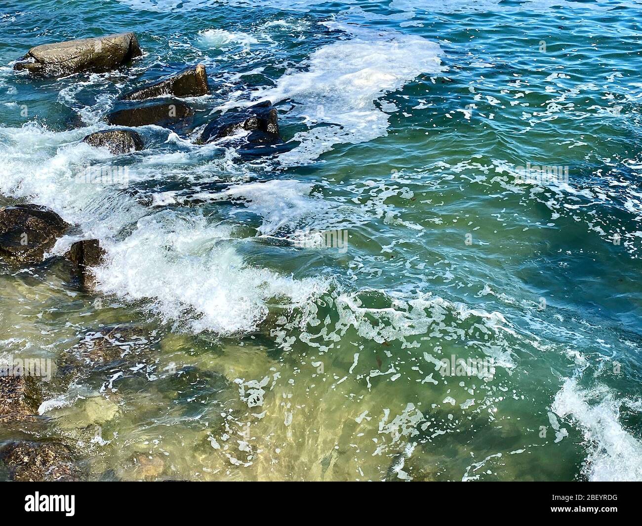 Mild storm surge creates sudsy ocean water Stock Photo - Alamy
