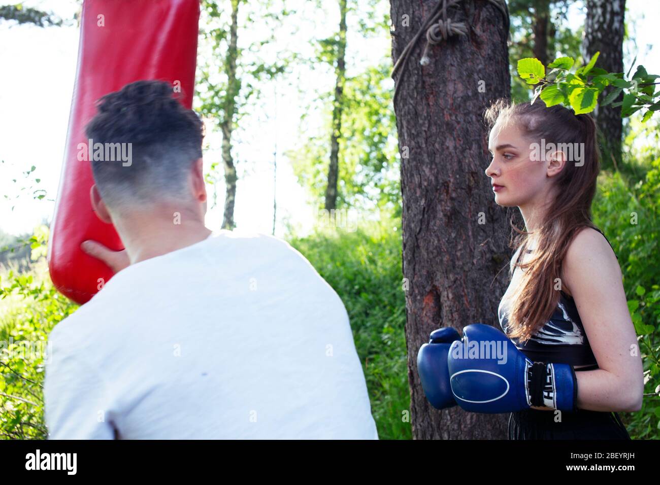 girls fighting boxing outside with coach in green park, sport summer ...