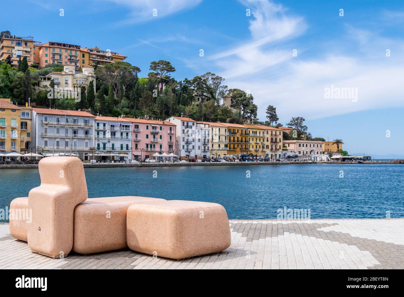 Bench on seafront in Porto Santo Stefano village in a sunny day with ...
