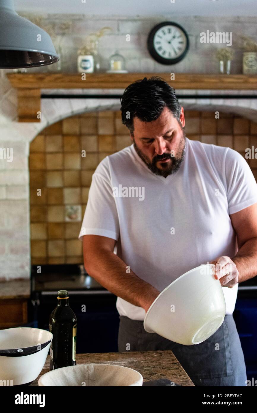 Portrait photograph of a man preparing home baked sourdough bread in ...