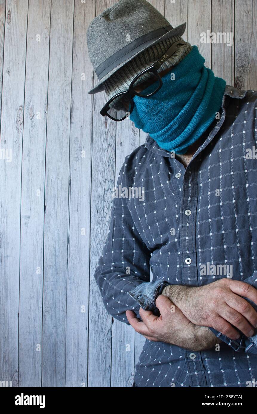 Self portrait of man with mask/scarf and hat with various gestures and ...