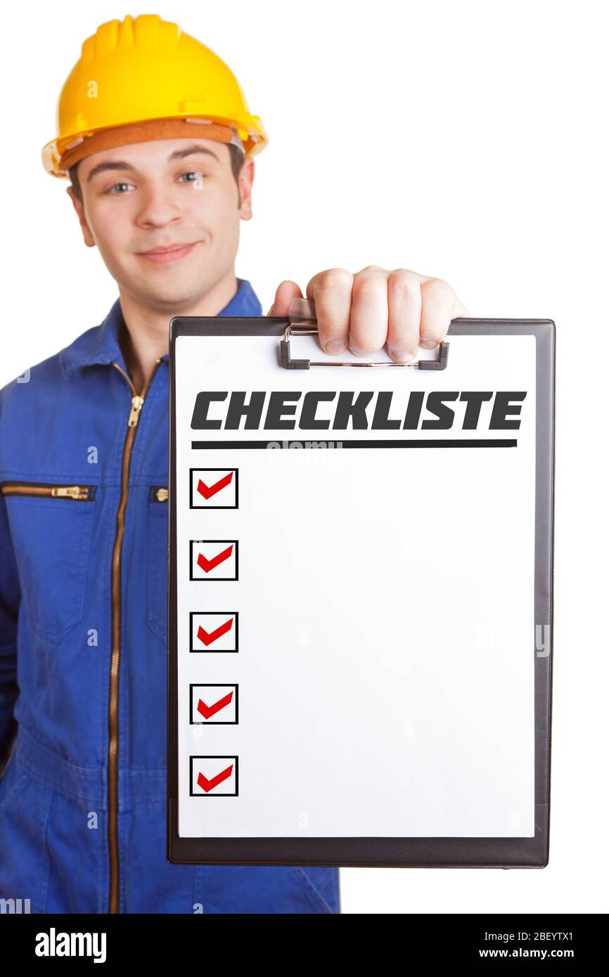 Craftsman in overalls with hard hat holds a clipboard with checklist ...