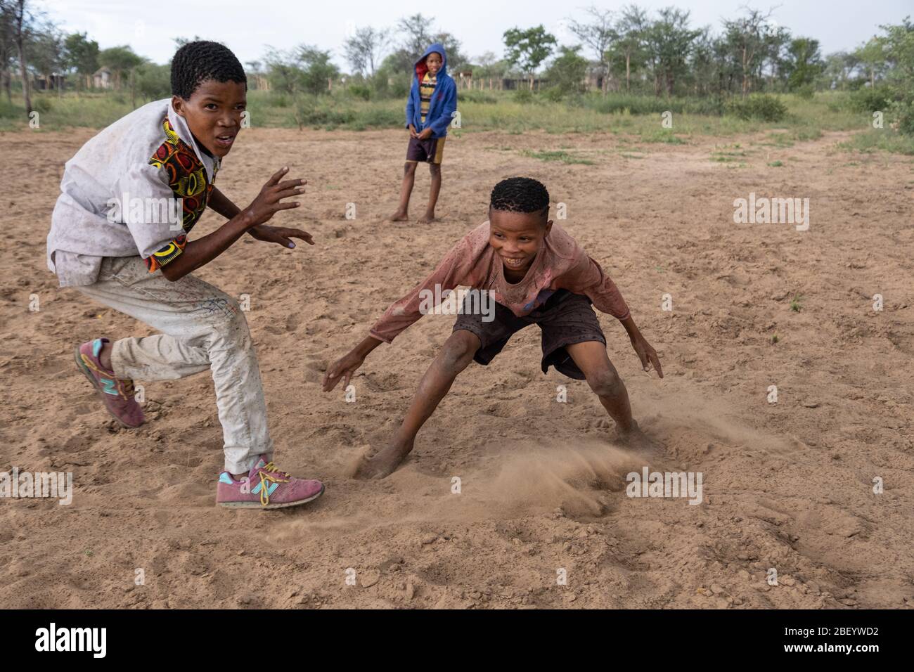 Young boys play in the dust. Nyae Nyae, Namibia Stock Photo - Alamy