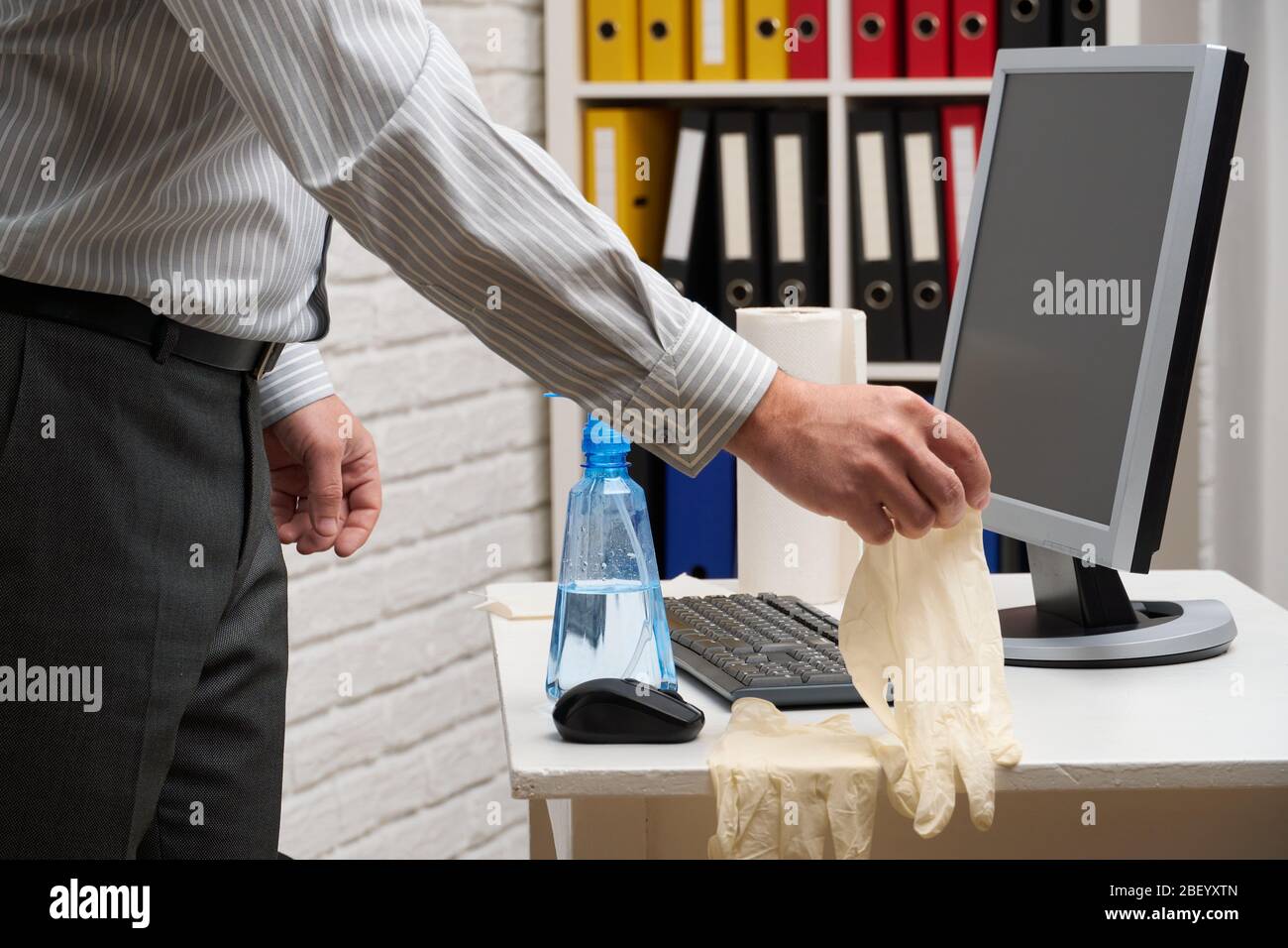 concept of cleaning or disinfecting the office - a businessman cleans ...