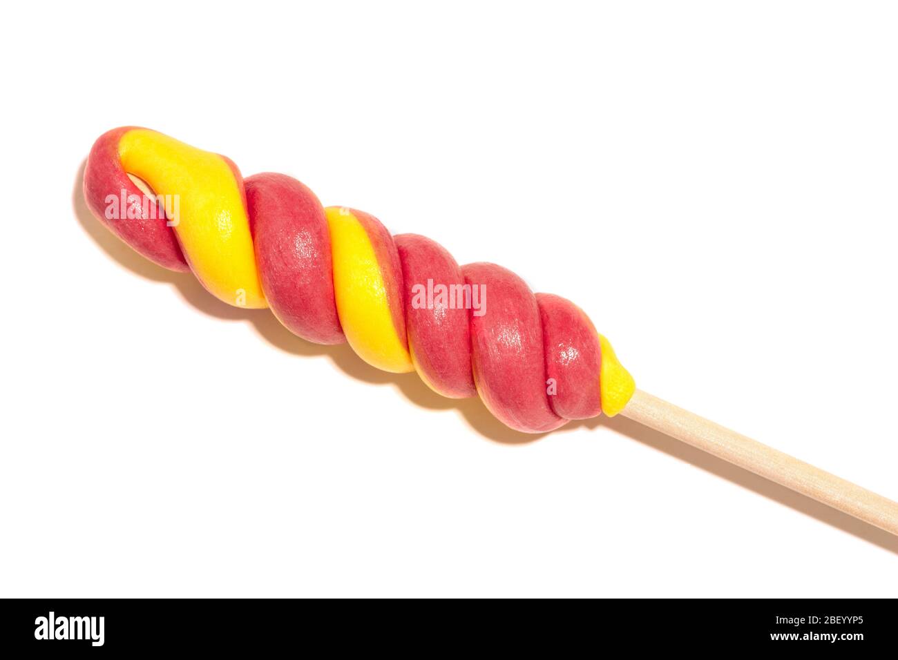 Bright, tasty, sweet and striped lollipop on a stick of red and yellow ...
