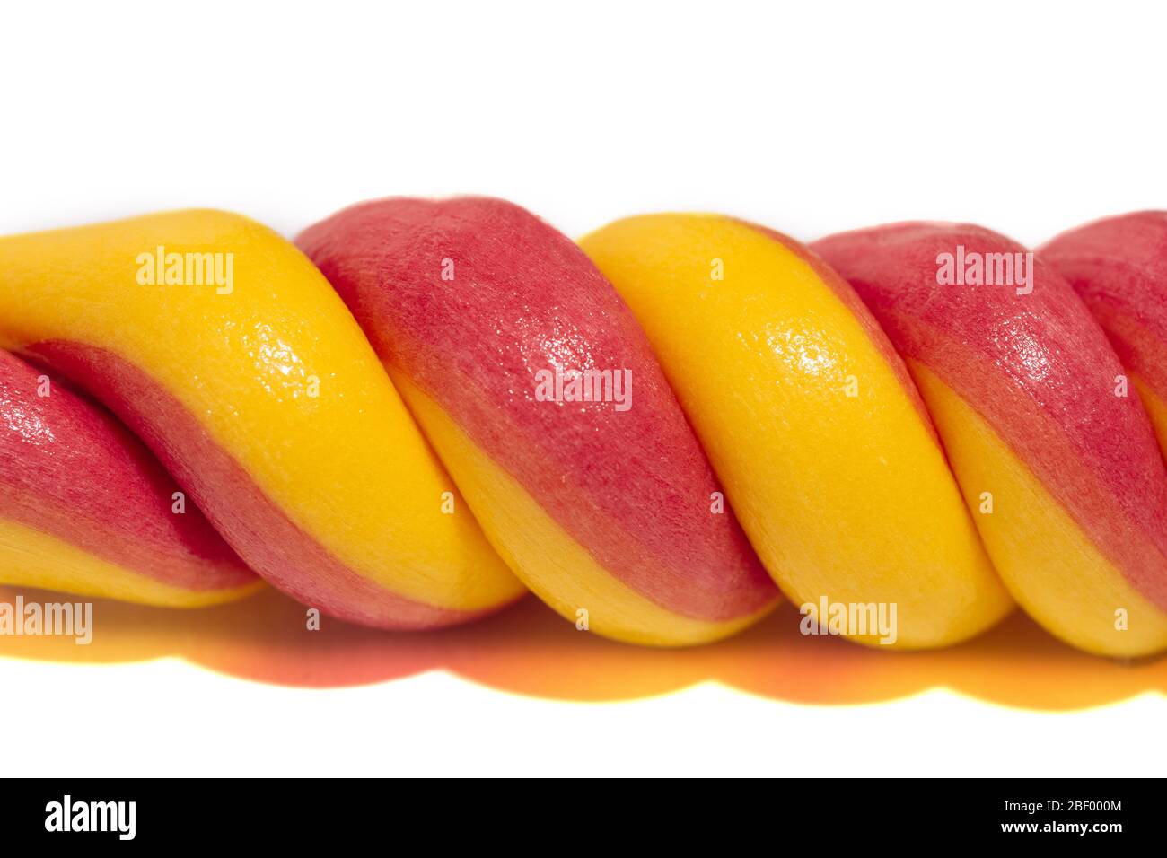 Bright, tasty, sweet and striped lollipop on a stick of red and yellow ...