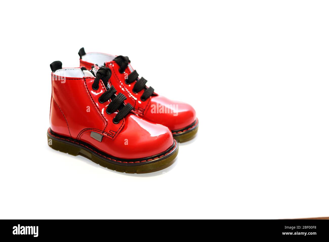 Children's beautiful shiny red boots isolated on the white background ...