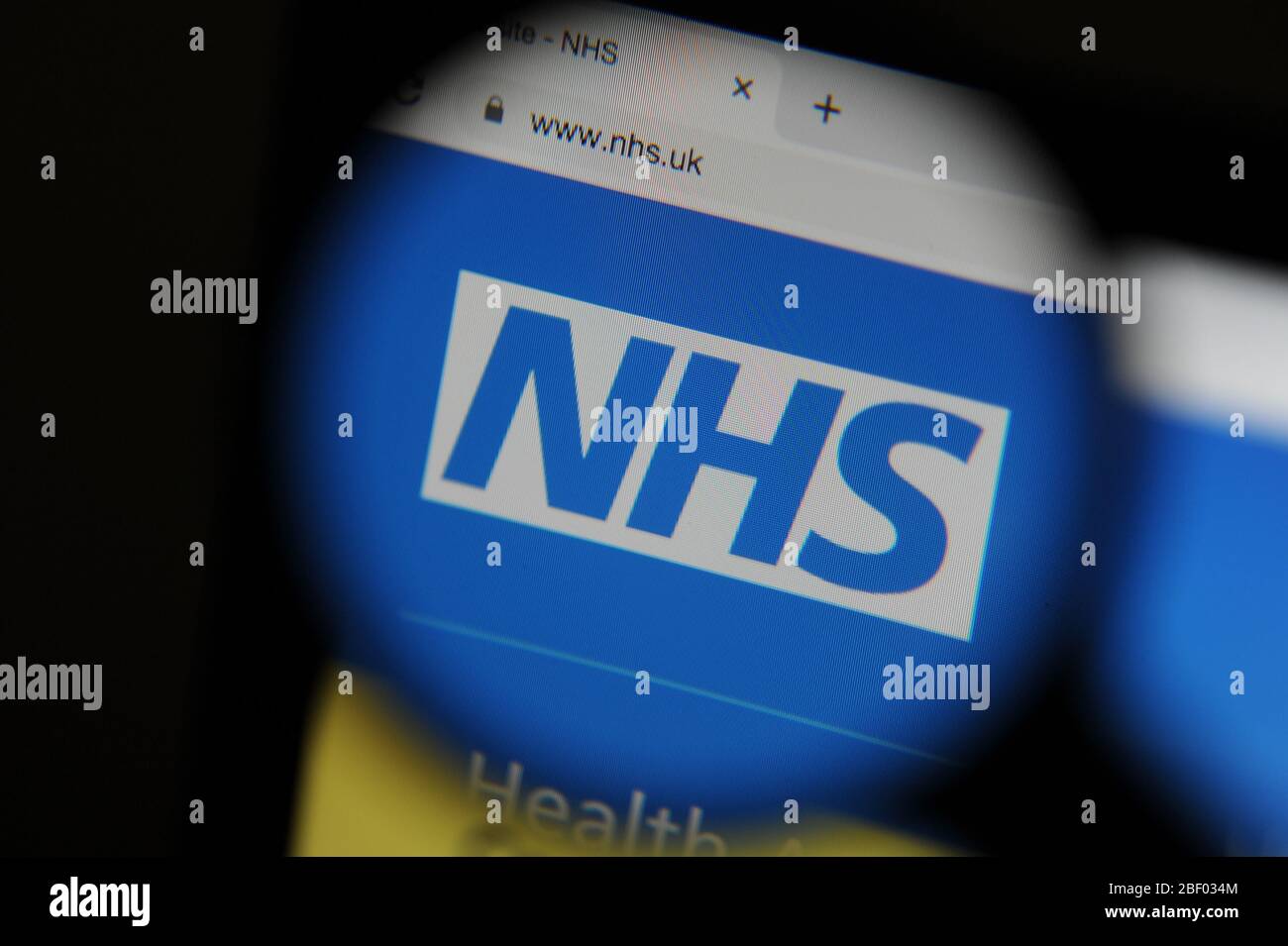 The NHS website seen through a magnifying glass on a computer Stock ...