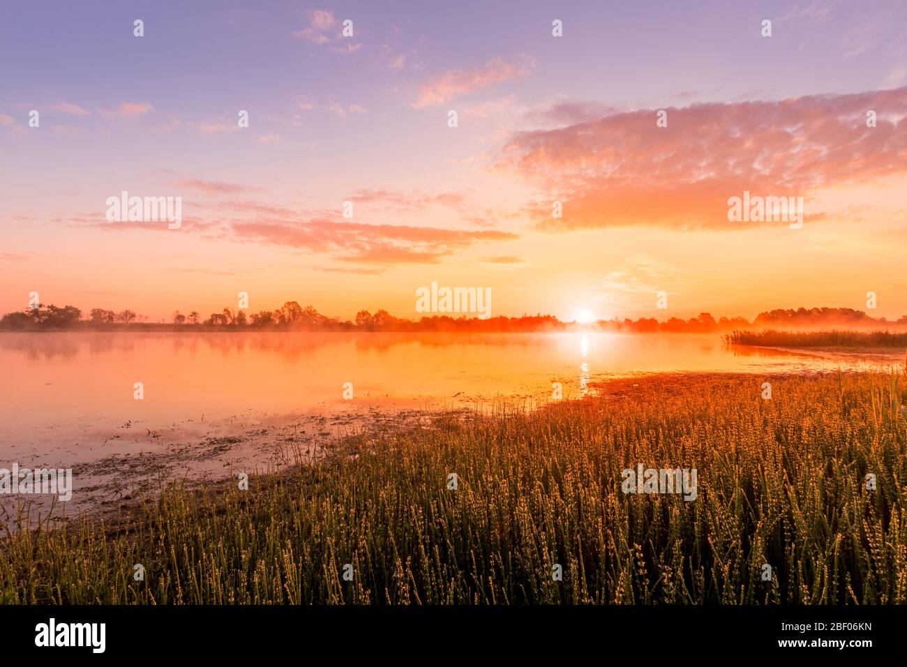 Scenic view of beautiful sunrise or dawn above the pond or lake at ...