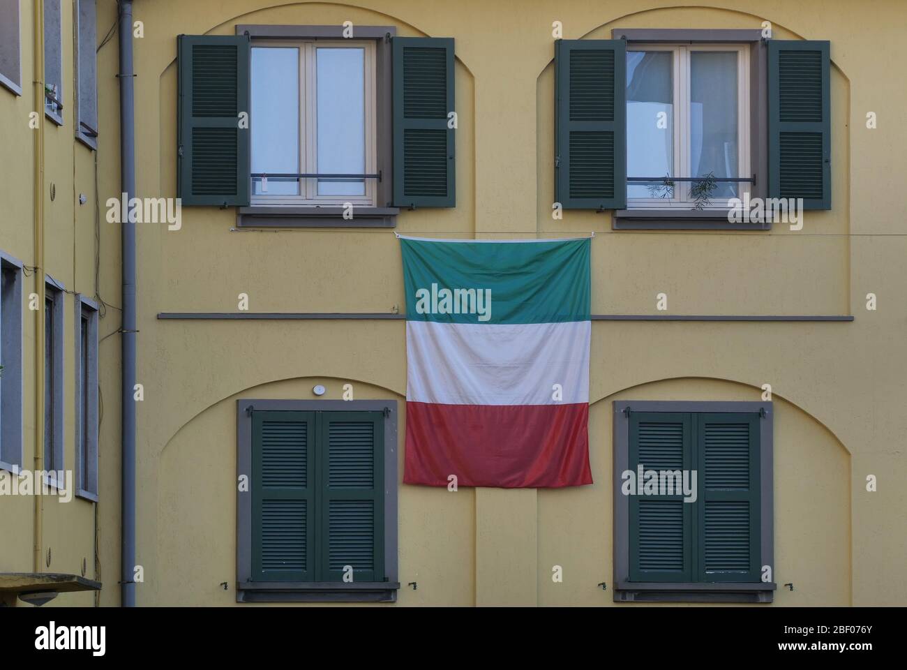 Italian flag exposed to the windows Stock Photo - Alamy