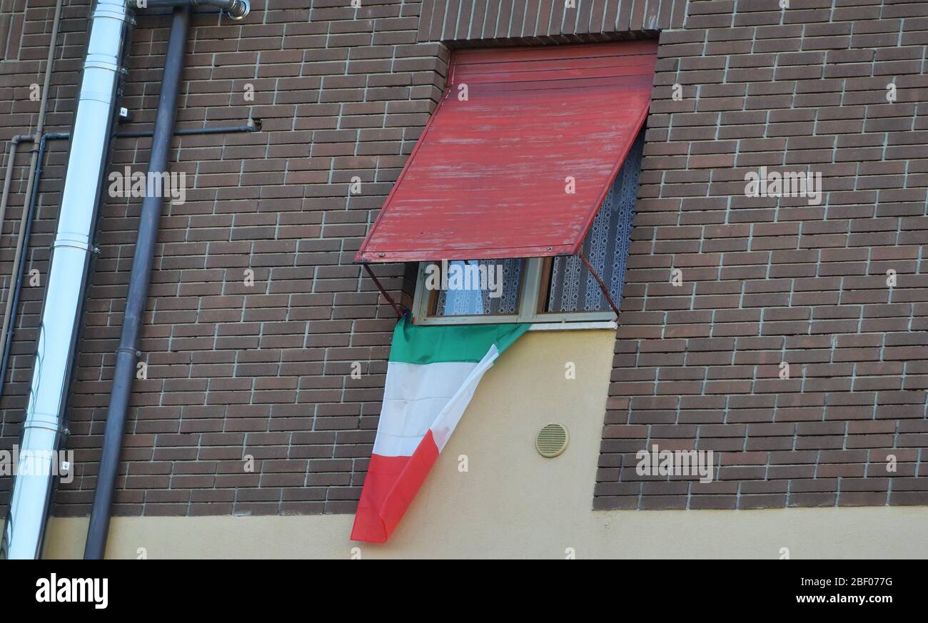 Italian flag exposed to the windows Stock Photo - Alamy