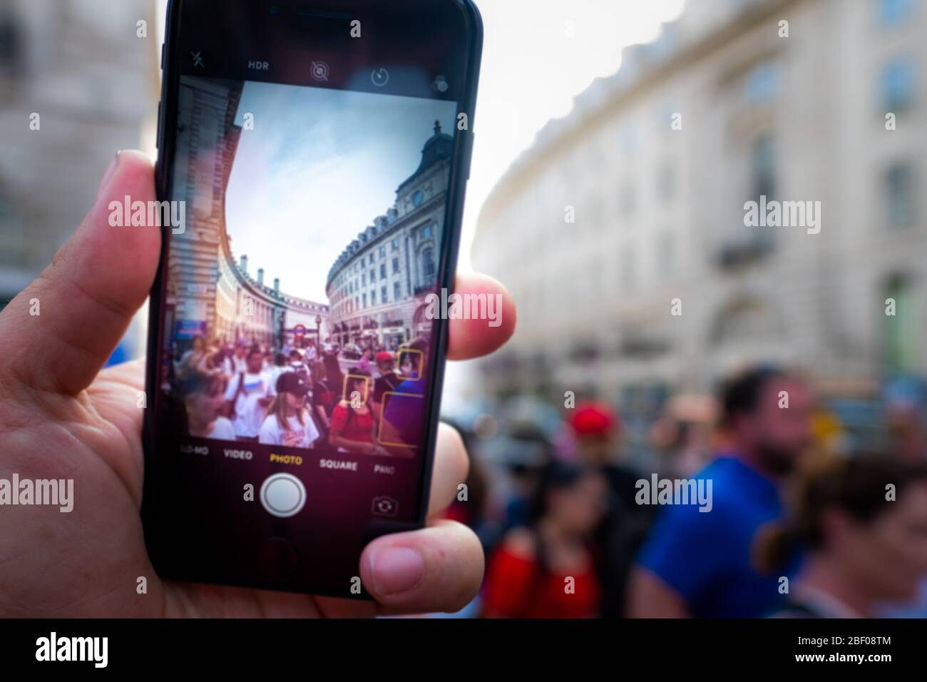 LONDON- Smart phone taking photos of Regent Street, a London landmark ...