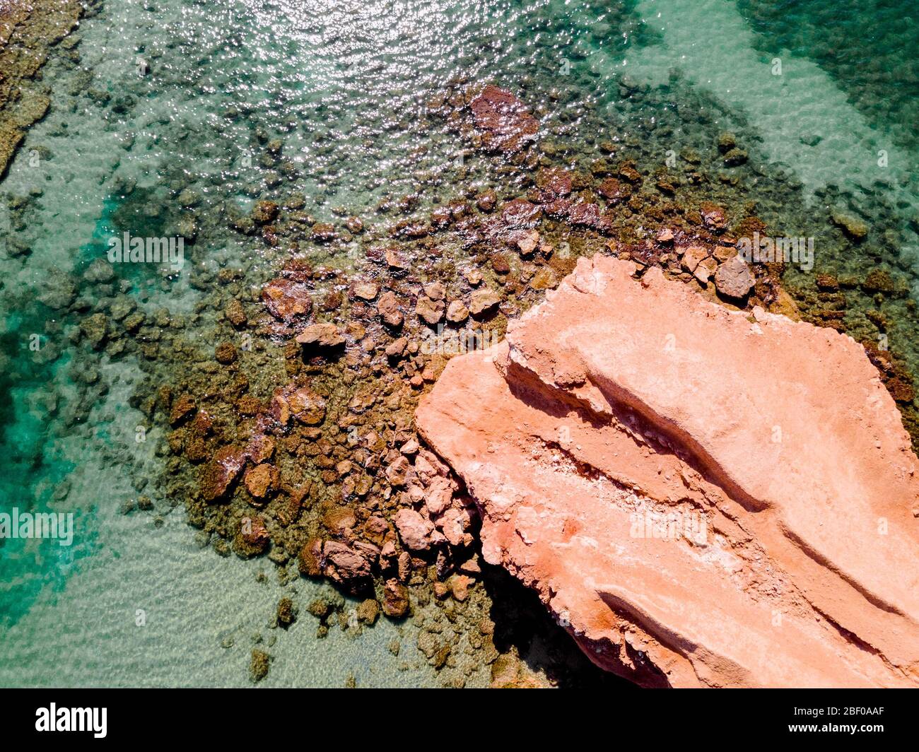 Aerial view of a natural rock jetty on the Mediterranean coast with ...