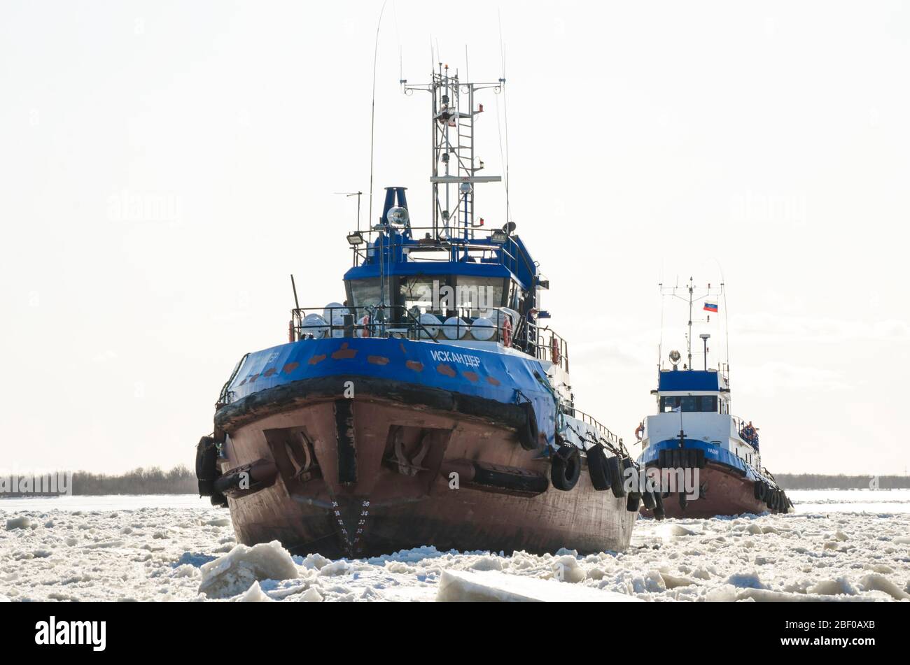 Tugboats work on the river. Spring navigation Stock Photo - Alamy