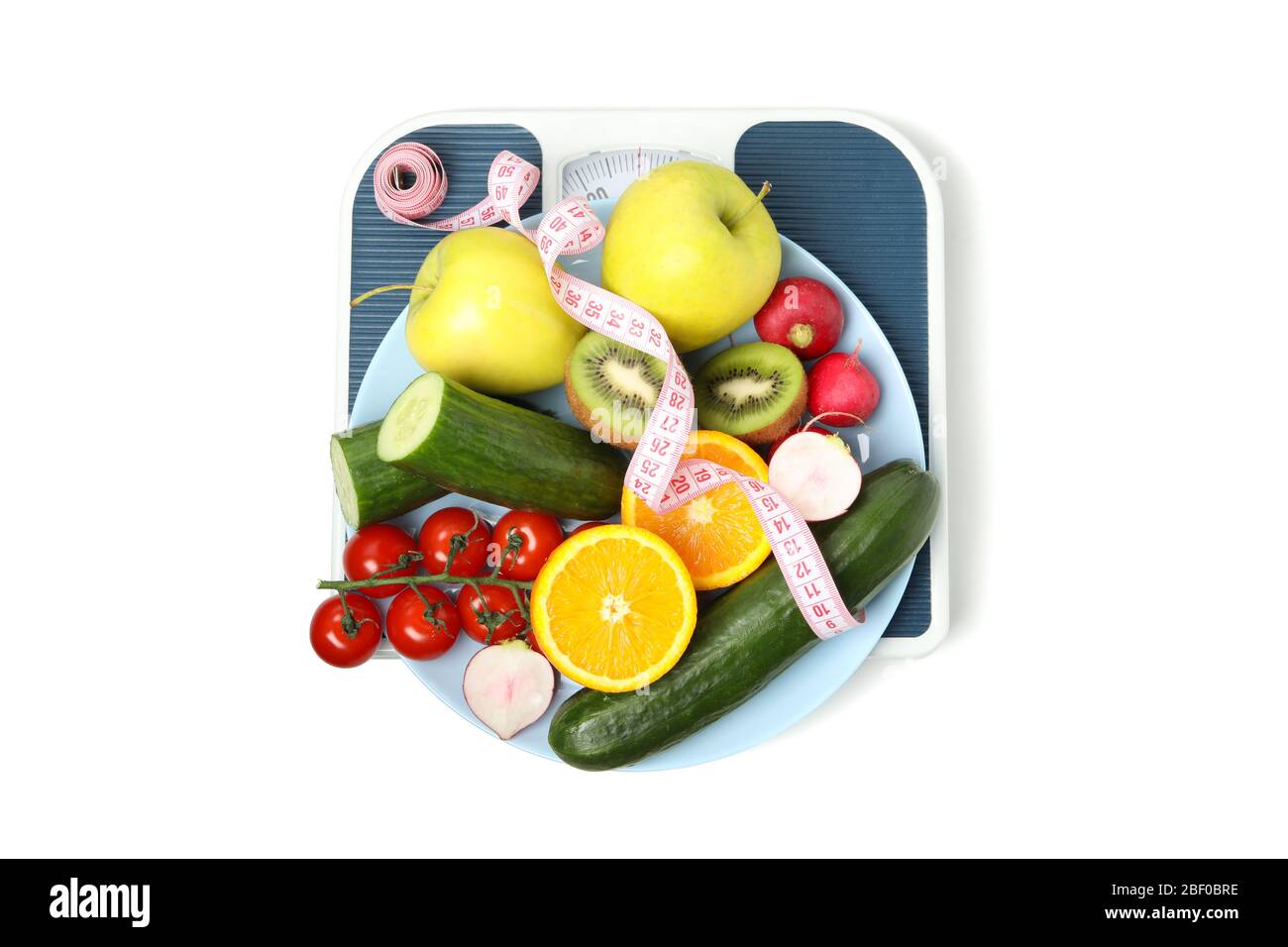 Scales, measuring tape and vegetarian food isolated on white background ...