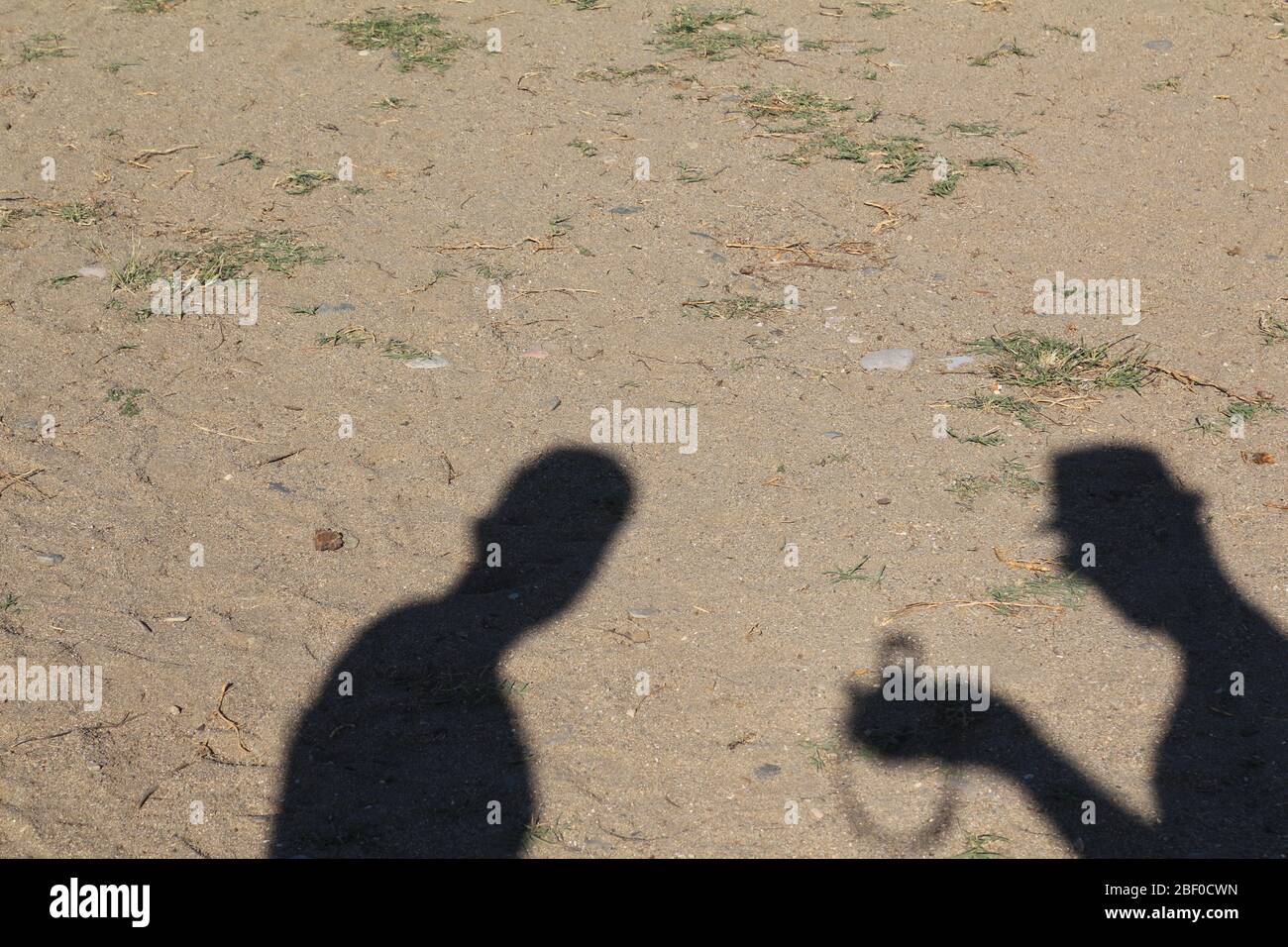 Shadow of two men on the sand at the beach Stock Photo - Alamy